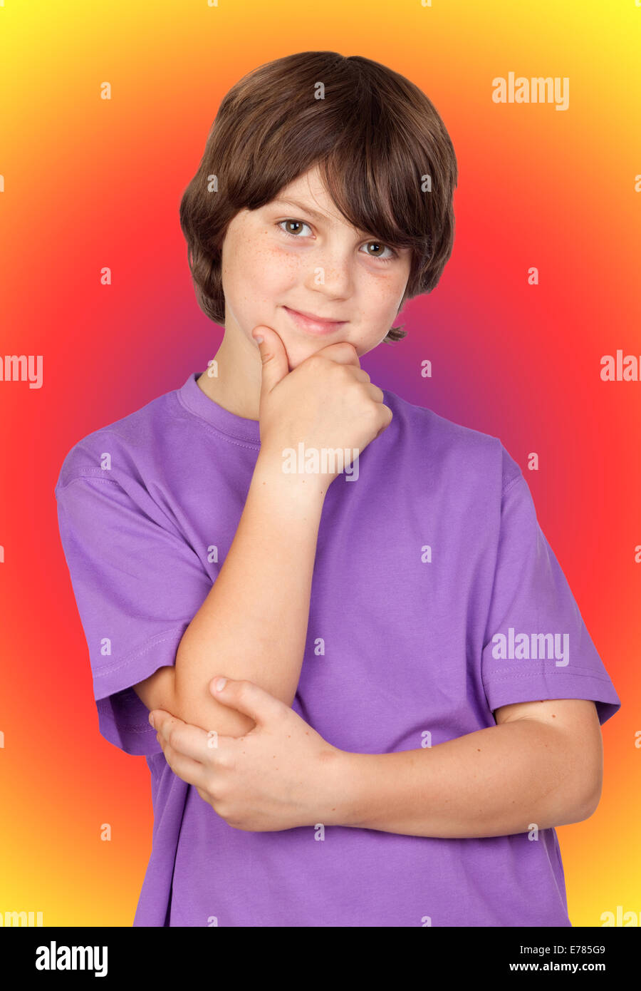 Pensive boy isolated on red and orange background Stock Photo - Alamy