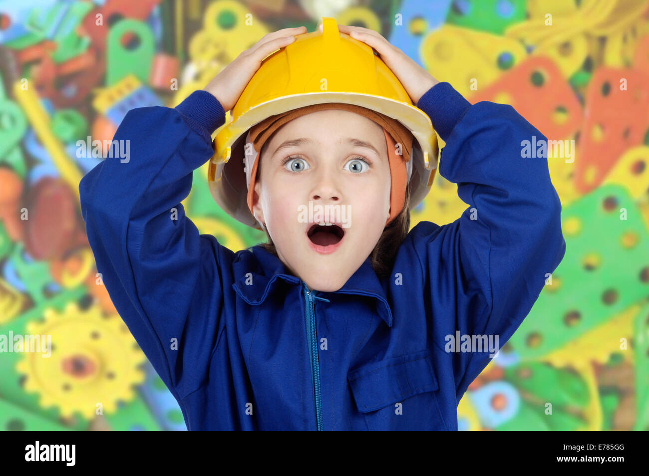 Surprised worker child with many installation components background ...