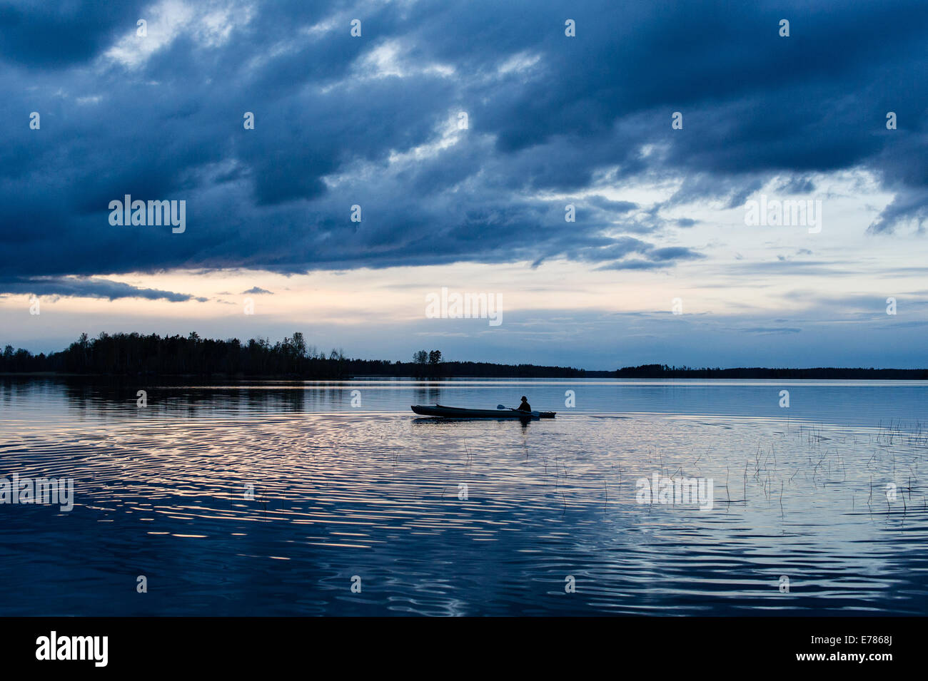 Sunset kayaking at lake Stock Photo - Alamy