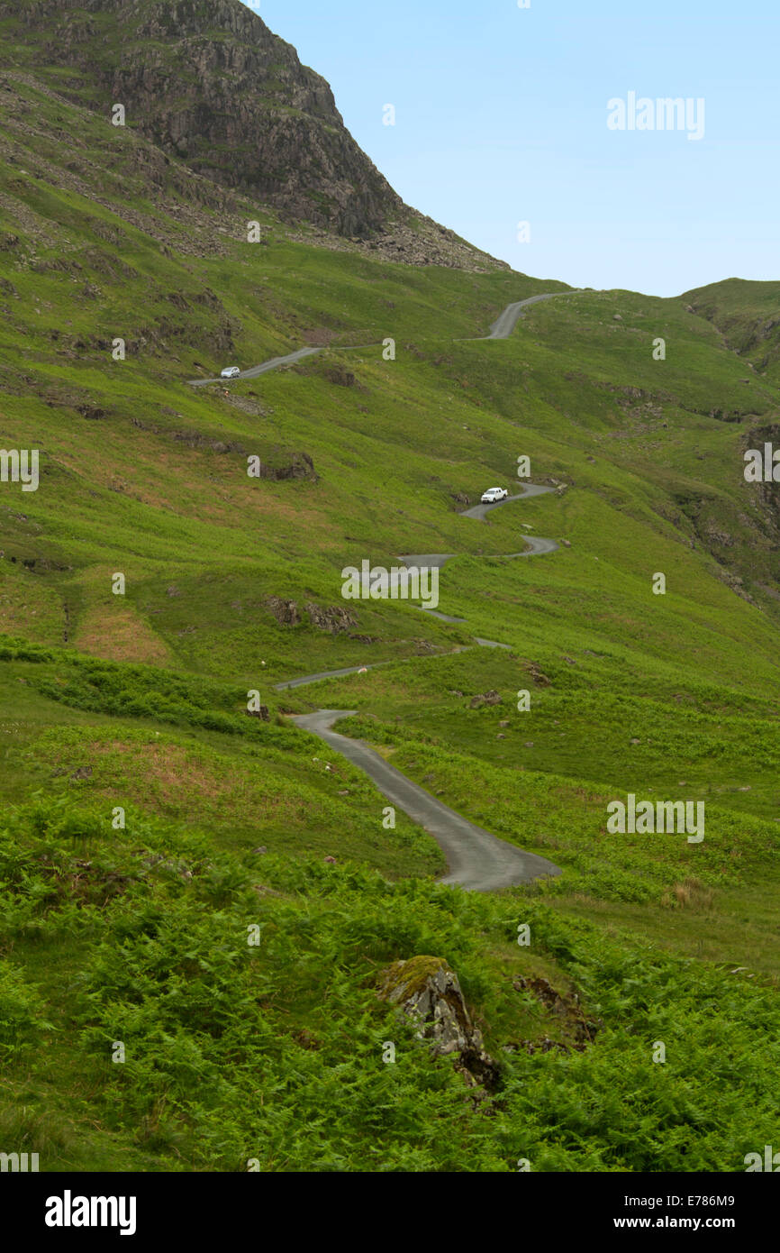 View of steep narrow road leading to summit of Hardknott Pass in ...