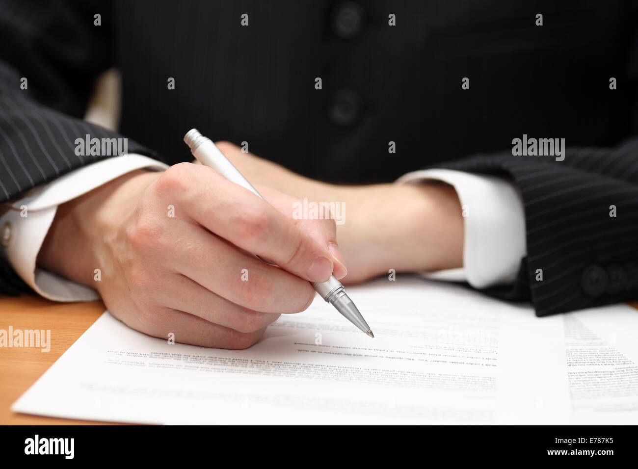 Businessman viewing the contract before signing. Close-up. Focus on pen ...