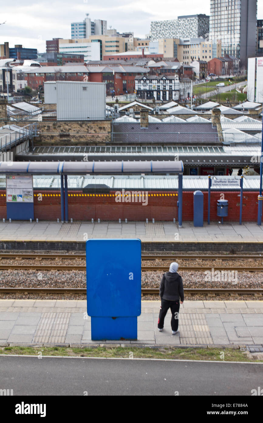 A man on a platform Sheffield railway station in Sheaf Square ...