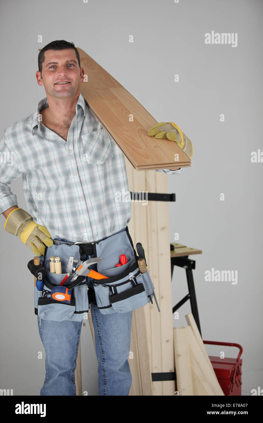 Carpenter carrying a wooden plank Stock Photo - Alamy