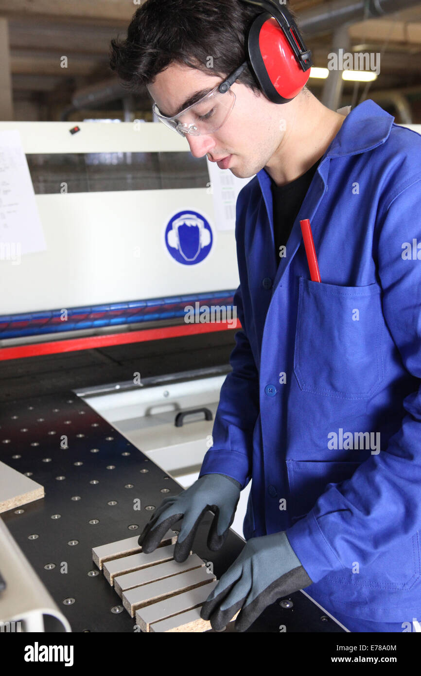 Young factory worker preparing machine Stock Photo - Alamy