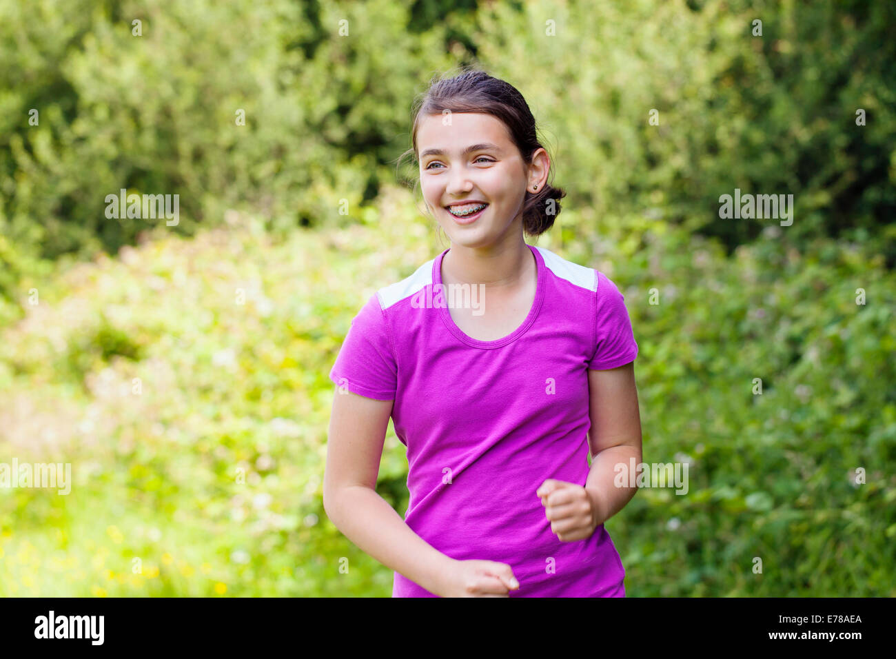 Teenage girl running in the park Stock Photo - Alamy