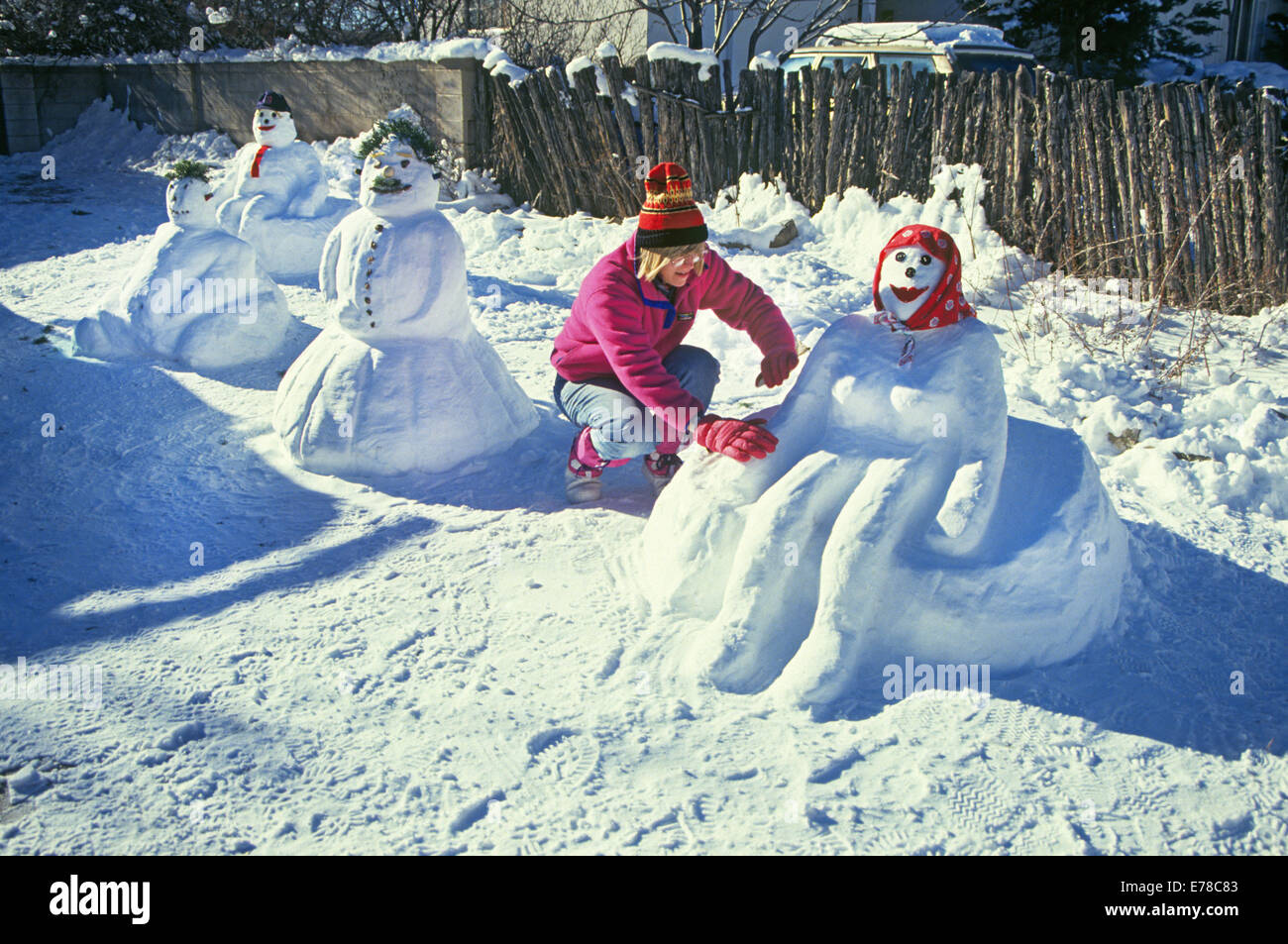 Woman making snow people or snow man in Santa fe, New Mexico, after a ...