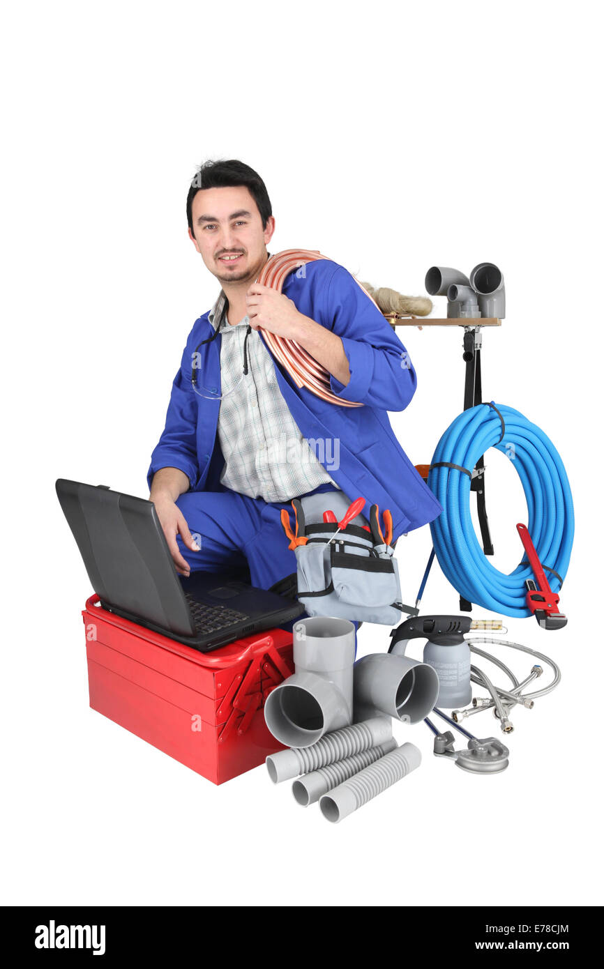 plumber kneeling with computer Stock Photo - Alamy