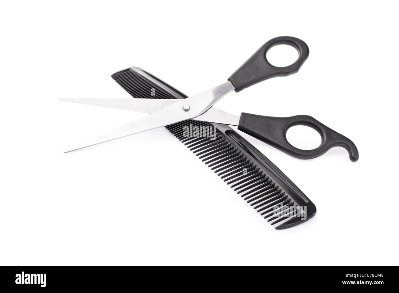 Crossed scissors and comb, isolated on white background Stock Photo - Alamy