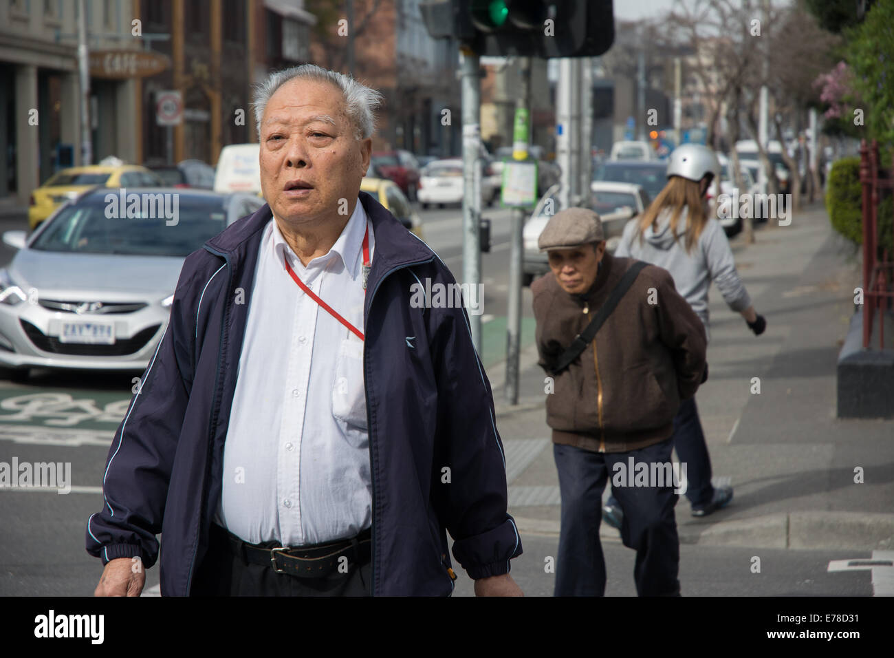Elderly Chinese Man Walking Across the Street Stock Photo - Alamy