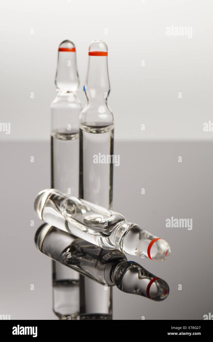 Three Clear medical ampules isolated on black background Stock Photo ...