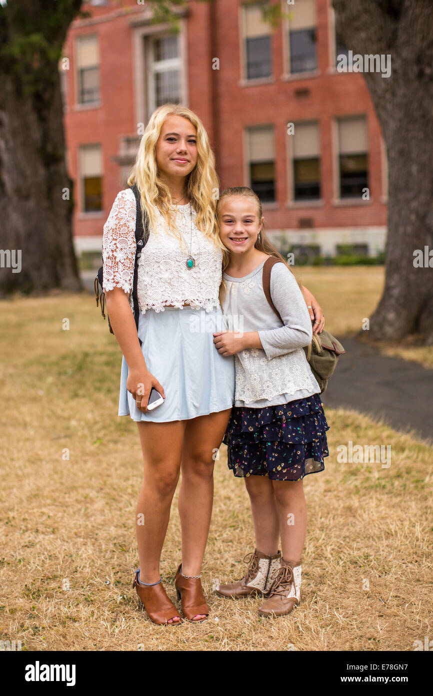 Portland, Oregon. Portrait of girls outside school talking on their ...