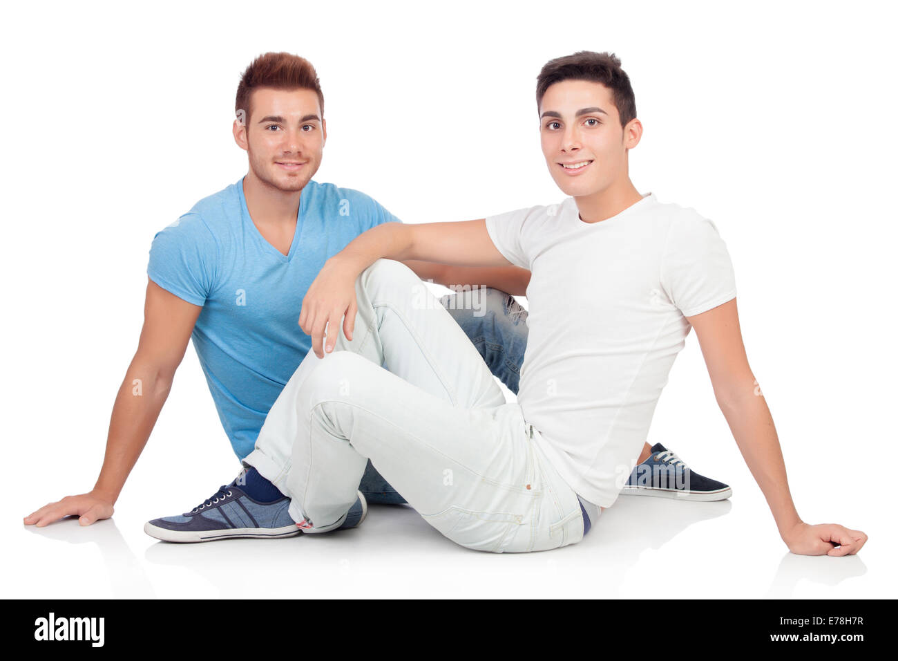 Portrait of two brothers sitting isolated on a white background Stock ...