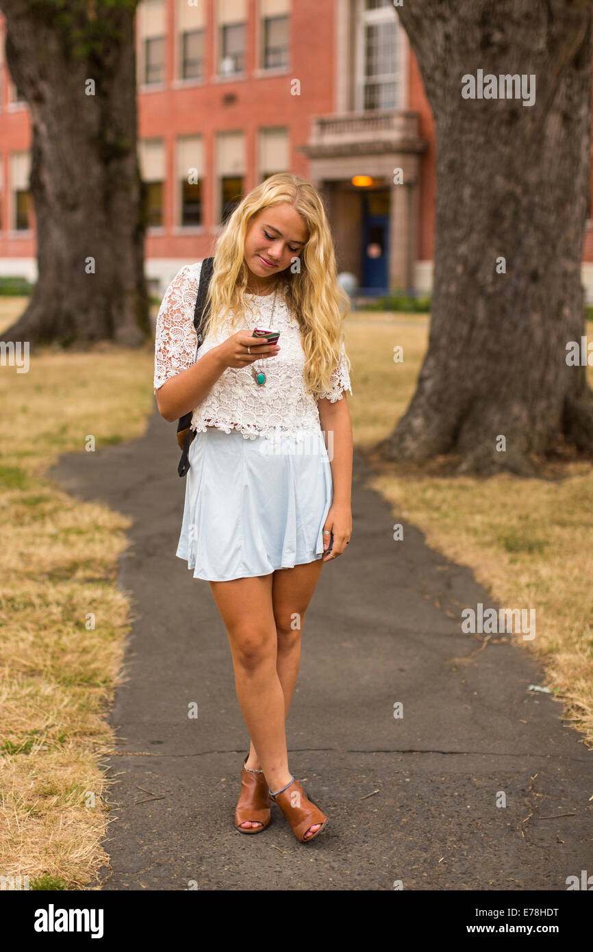 Portland, Oregon. Portrait of girls outside school talking on their ...