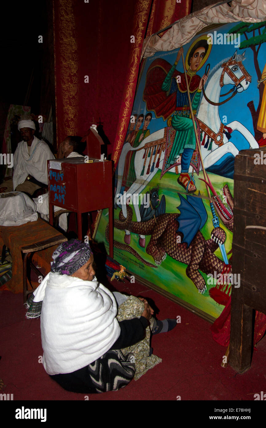 Woman in church contemplates image of St George slaying dragon Stock ...