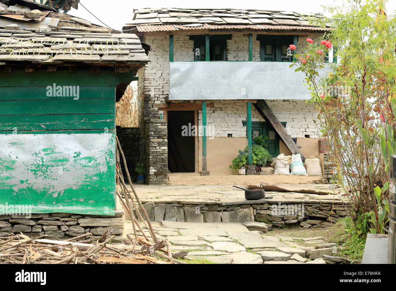 Traditional green and white painted homestead with slate and tin roofs ...