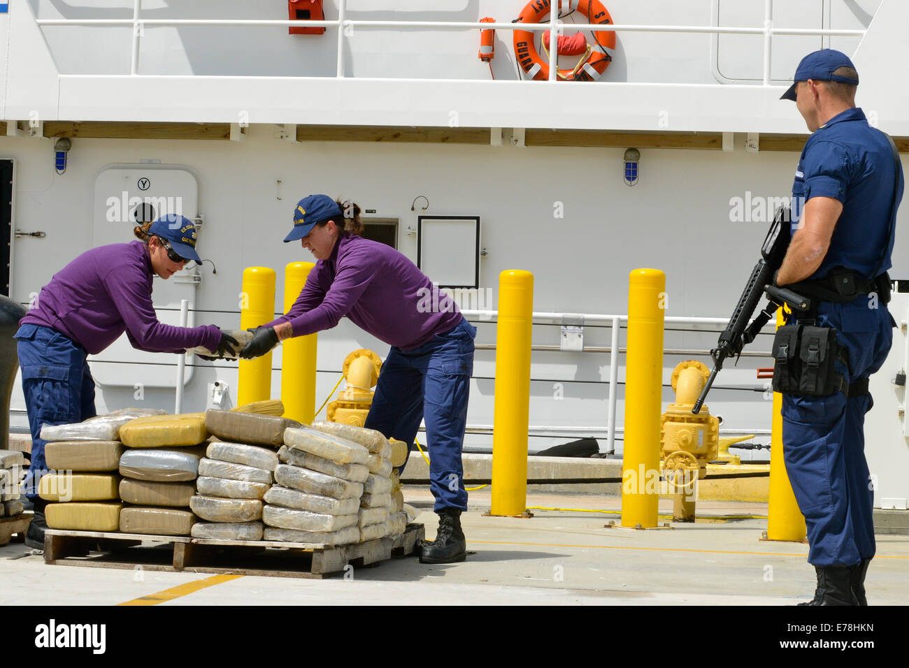 U.S. Coast Guard Petty Officer 2nd Class Joshua Coaker, right, assigned ...