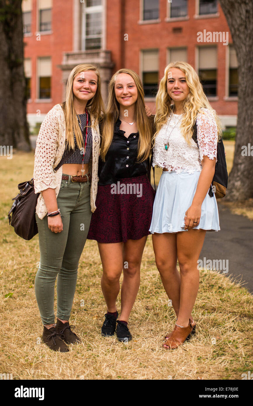 Portland, Oregon. Portrait of girls outside school talking on their ...