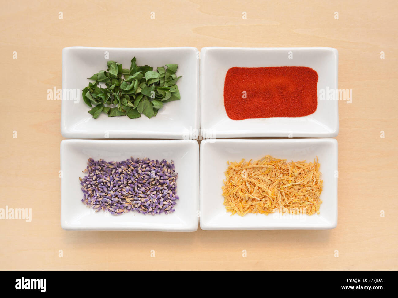 Four white bowls filled with colorful spices Stock Photo - Alamy