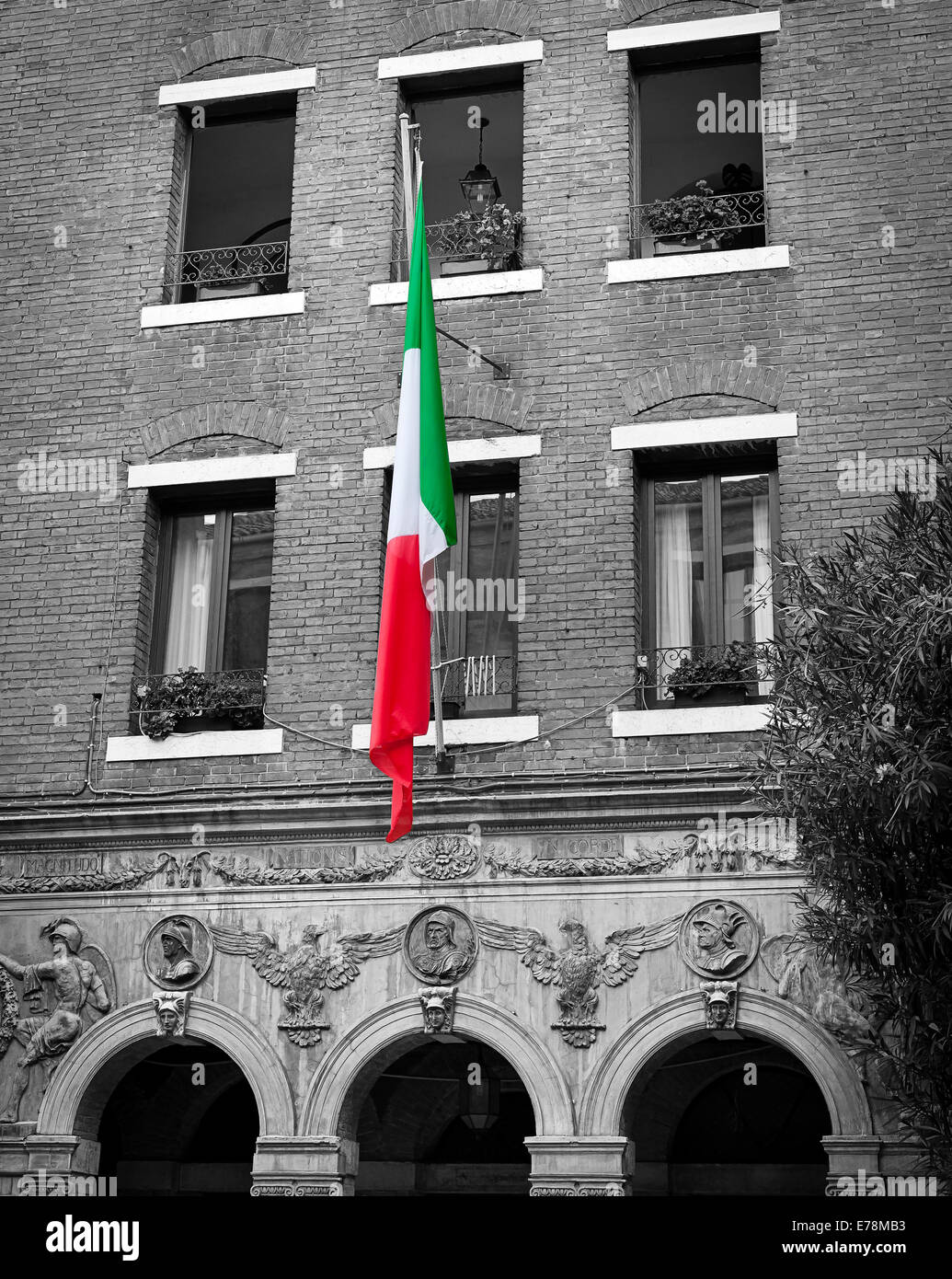 Italian flag in colour against a grey brick building; Venice, Italy ...