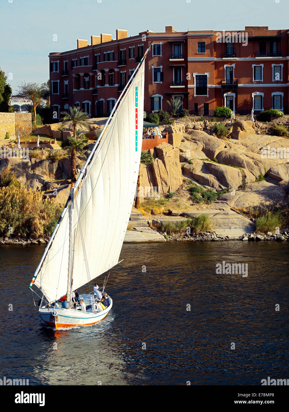 A felucca making its way downstream past the Old Cataract Hotel in ...