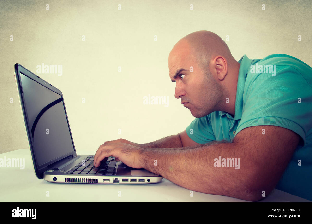 Bald man looking at the laptop computer Stock Photo - Alamy