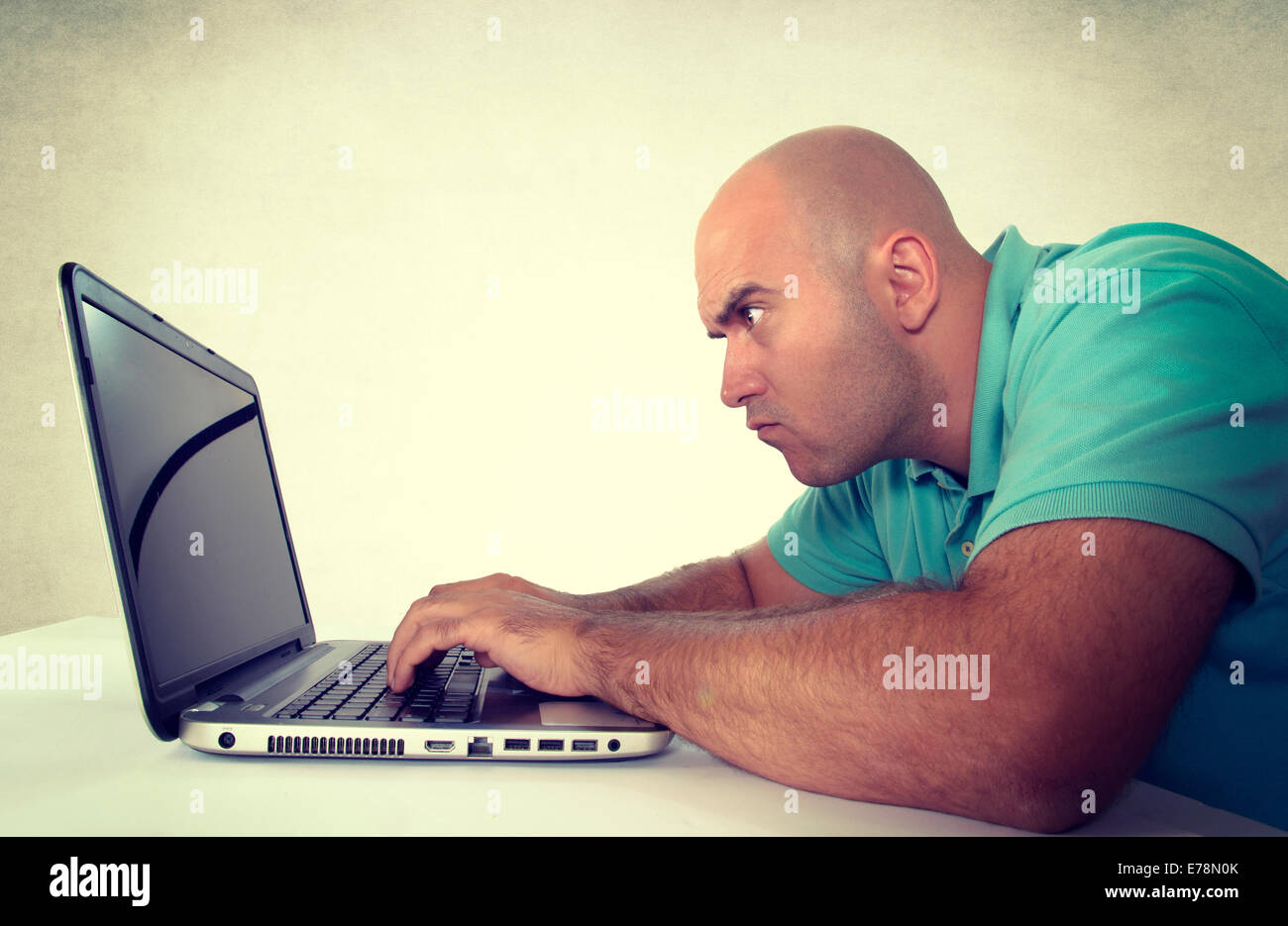 Bald man looking at the laptop computer Stock Photo - Alamy