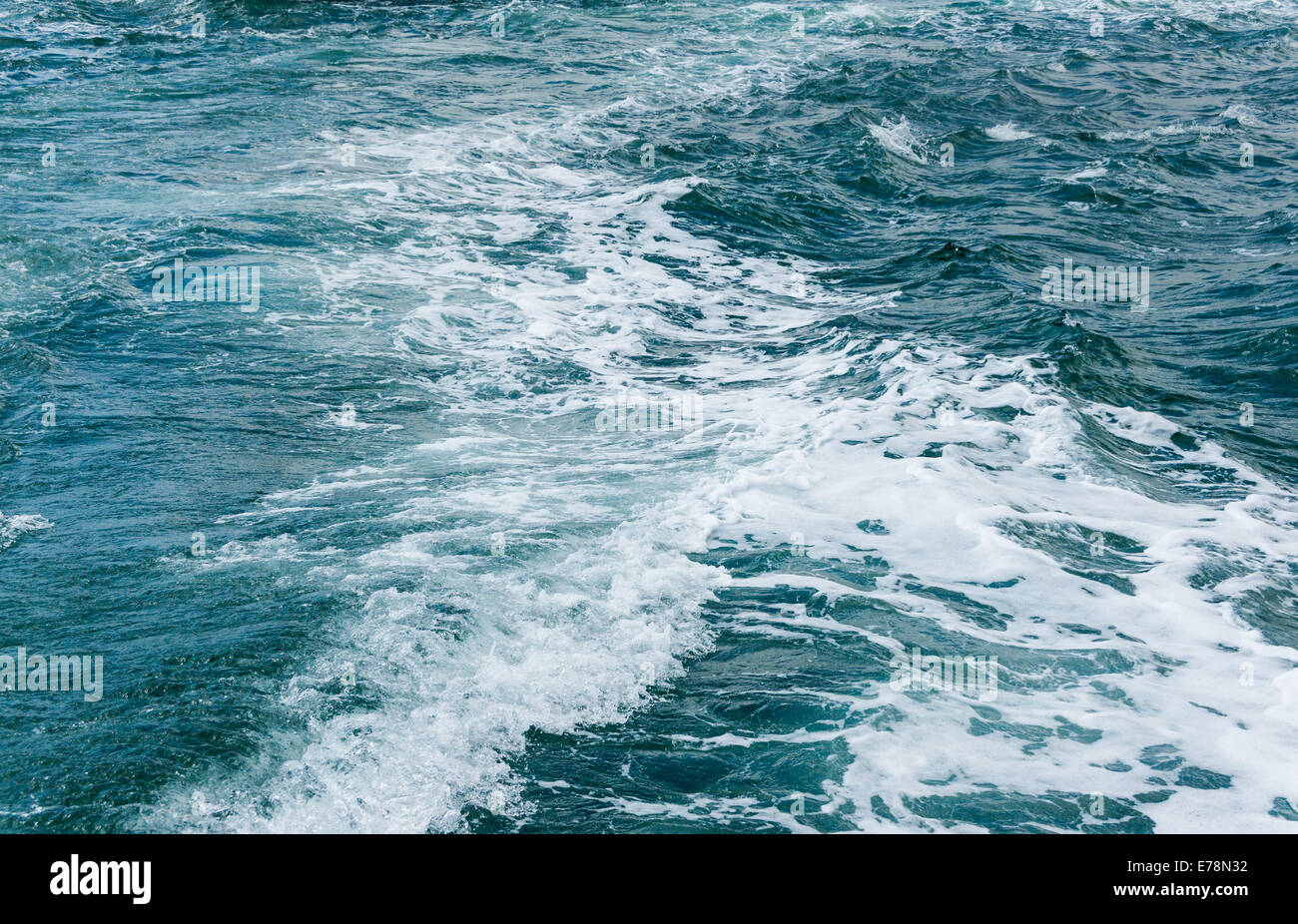 The image depicts the wake left by a boat as it moves through the water ...