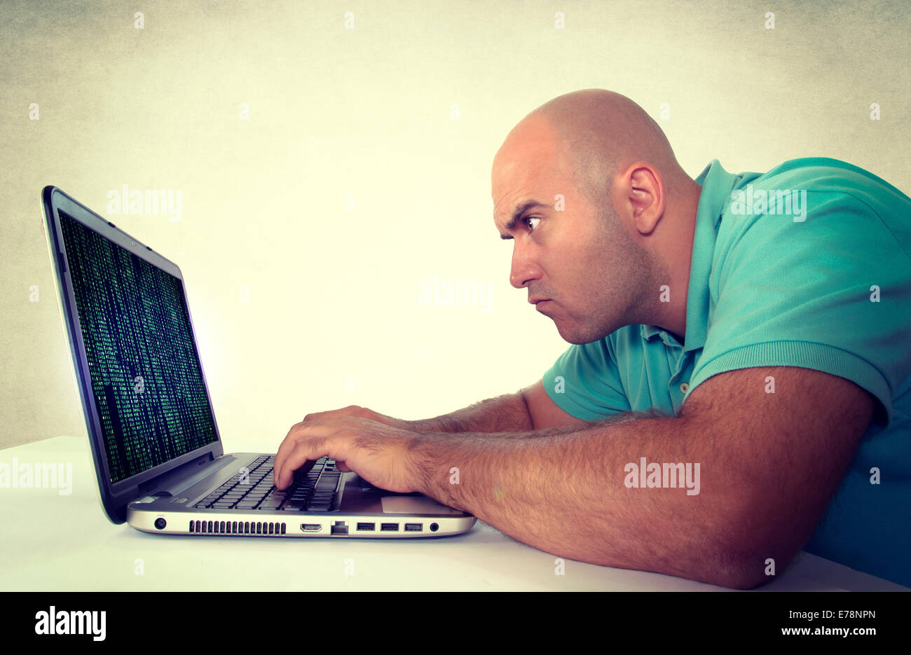Bald man programming on his laptop Stock Photo - Alamy