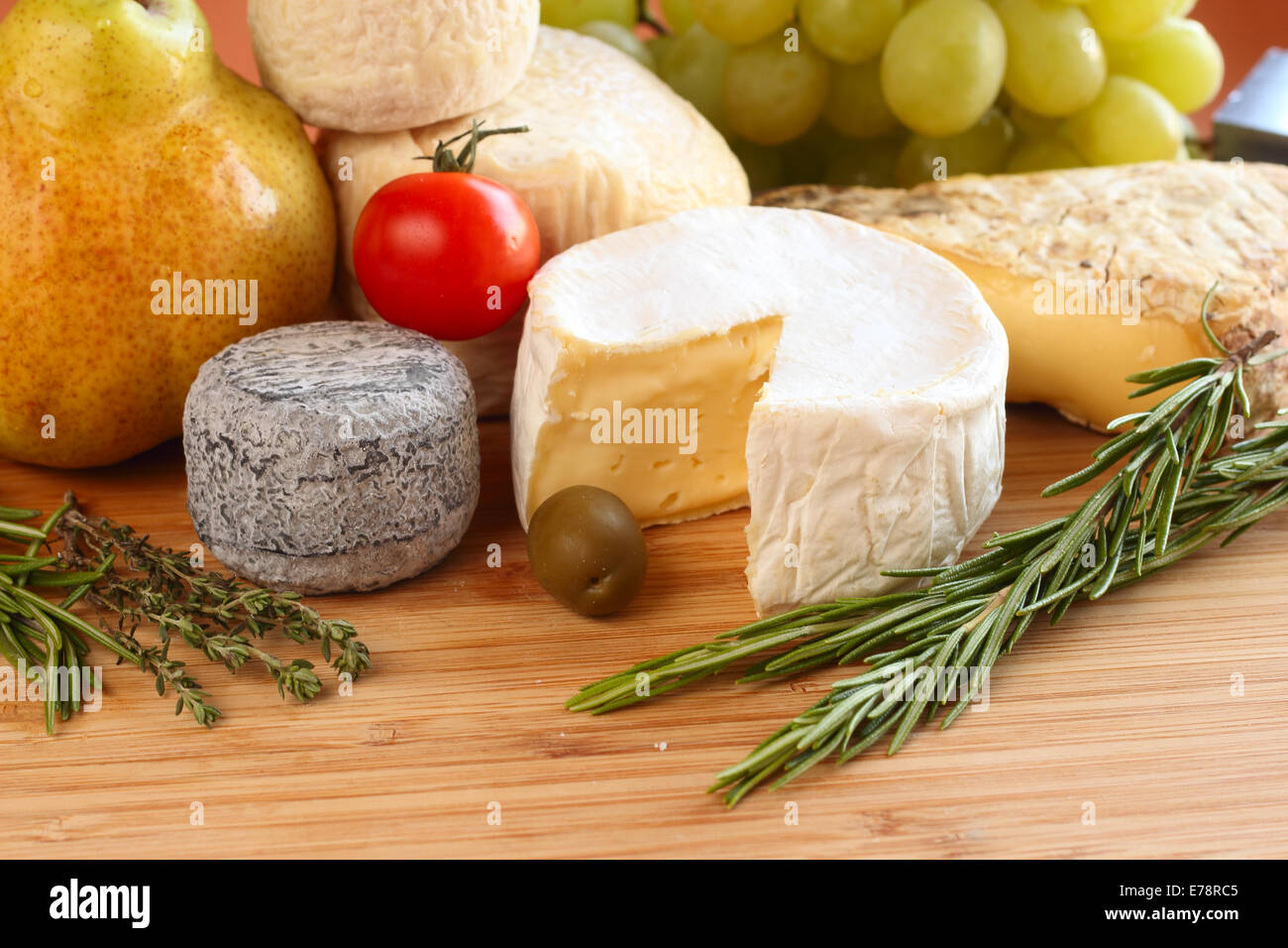 French cheese composition on wooden plank table Stock Photo - Alamy