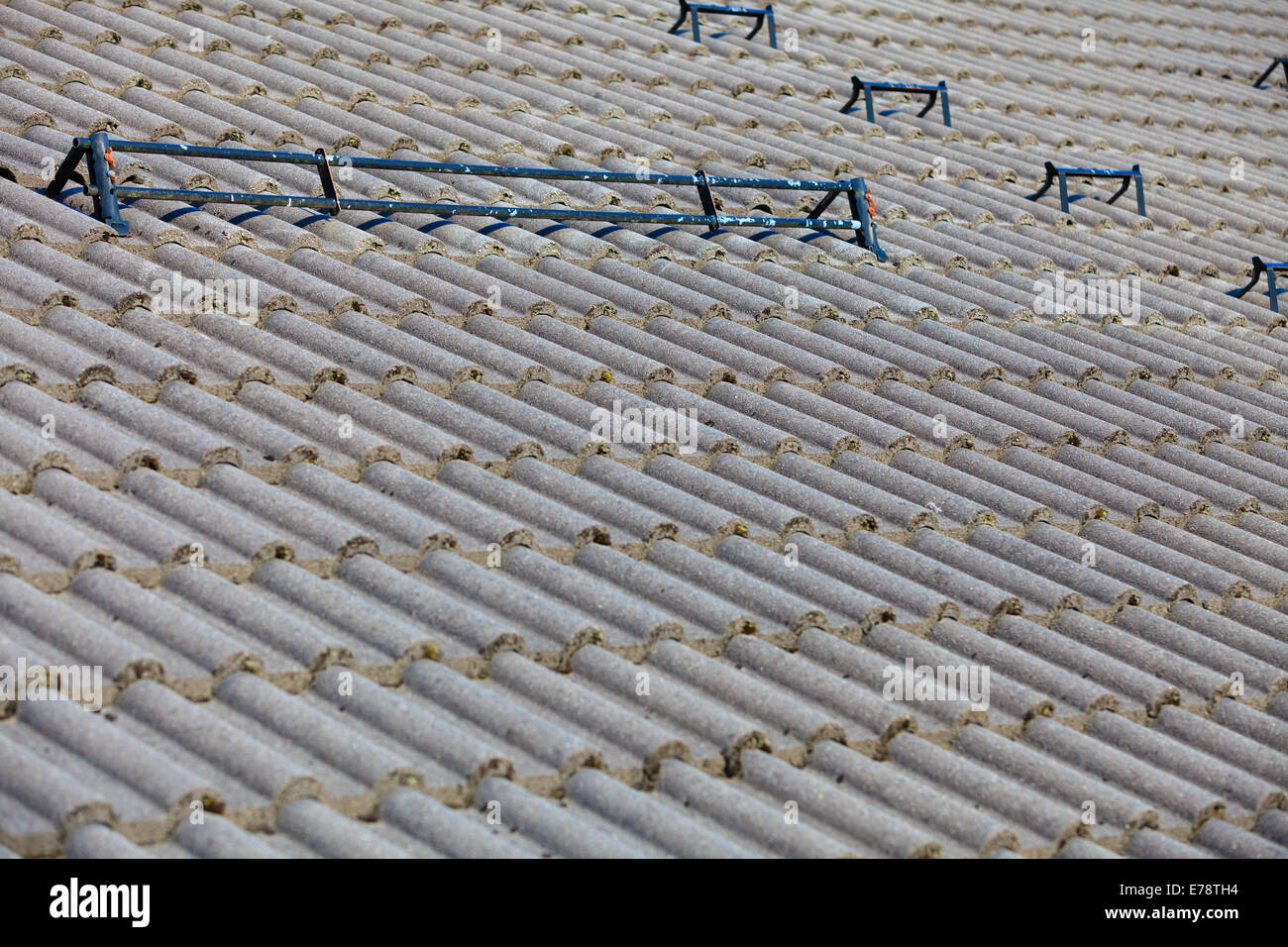 The roofing tiles house roof background with safety metal ladder to ...