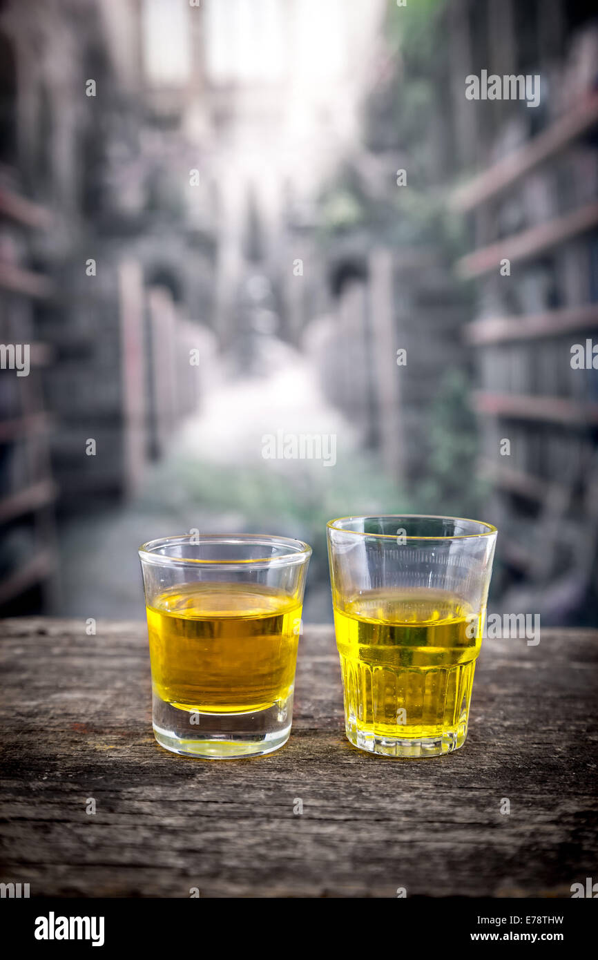 glass shots with yellow liqour resembling whiskey, rum, tequila, spirit ...
