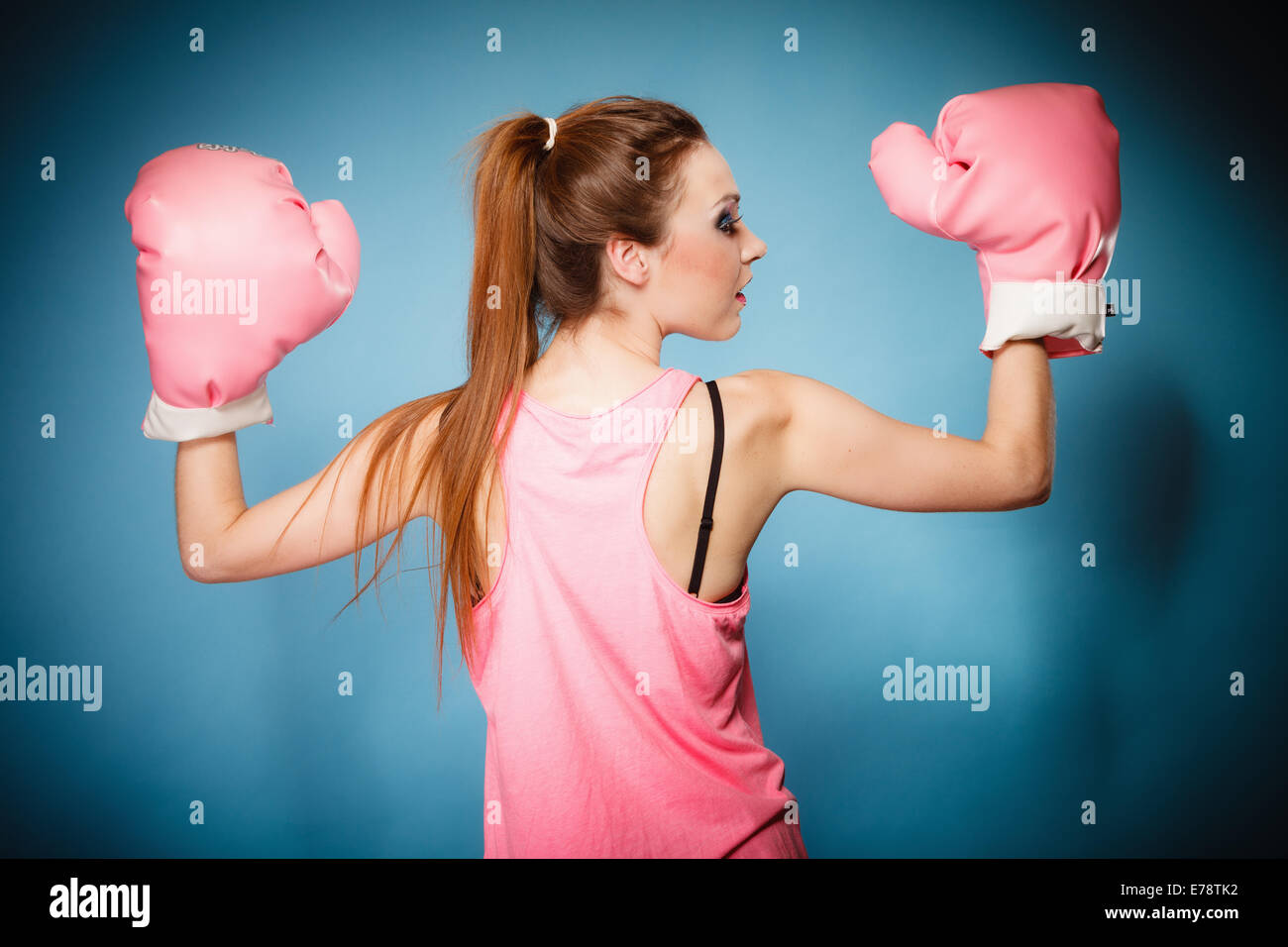 Funny girl female boxer model wearing big fun pink gloves playing ...