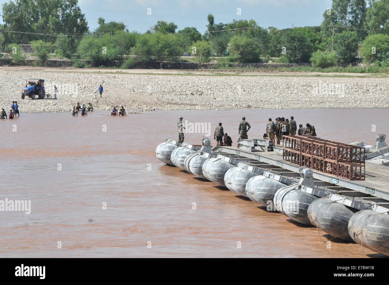 Soldiers of Indian Army's engineer core, make a pontoon bridge across ...