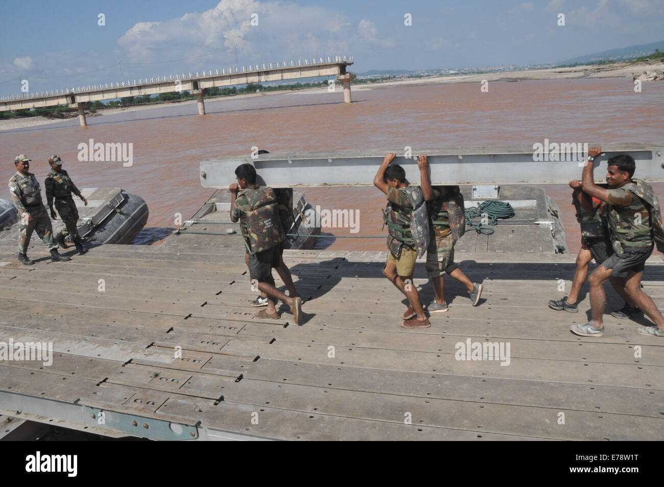 Soldiers of Indian Army's engineer core, make a pontoon bridge across ...