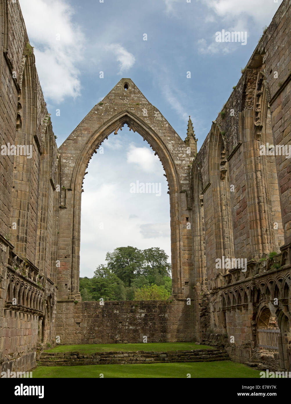 Imposing ruins of historic Bolton Abbey priory with immense arch of ...