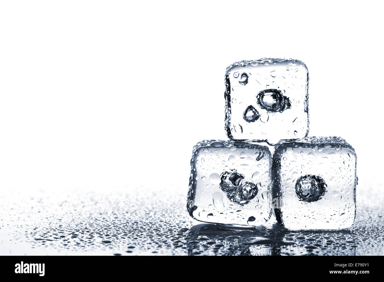 Melting ice cubes with air bubbles inside on white background with copy ...