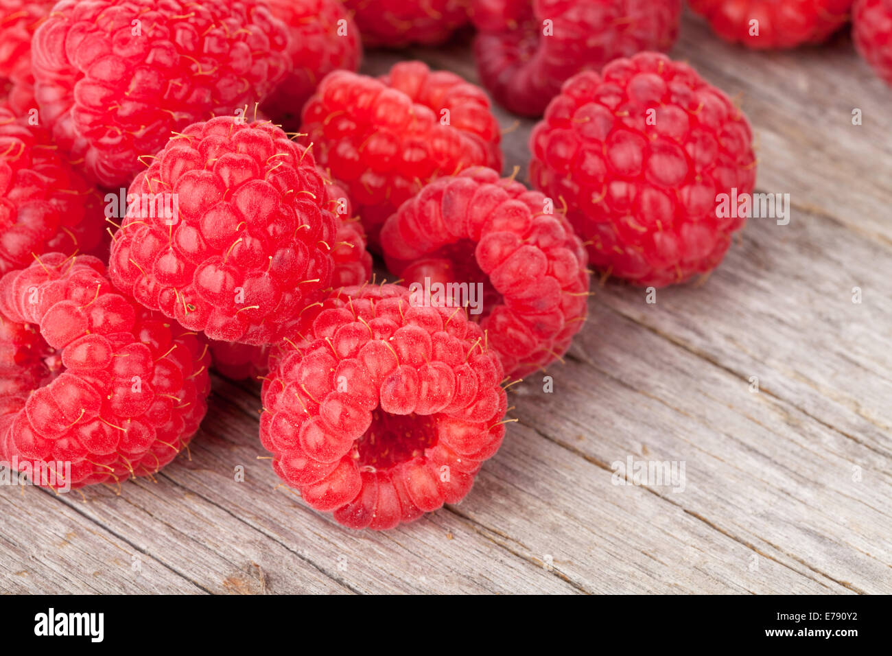 Fresh ripe raspberries on wooden table background Stock Photo - Alamy