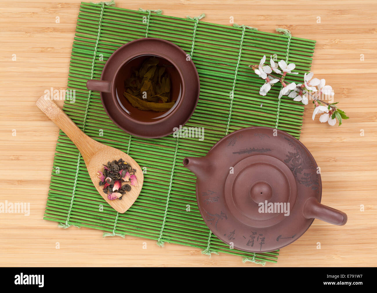Japanese green tea and sakura branch over bamboo table Stock Photo - Alamy