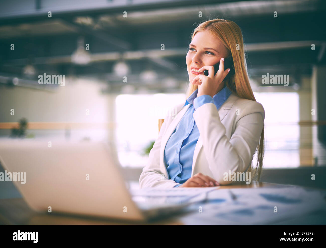 Young female agent speaking to client on the phone in office Stock ...