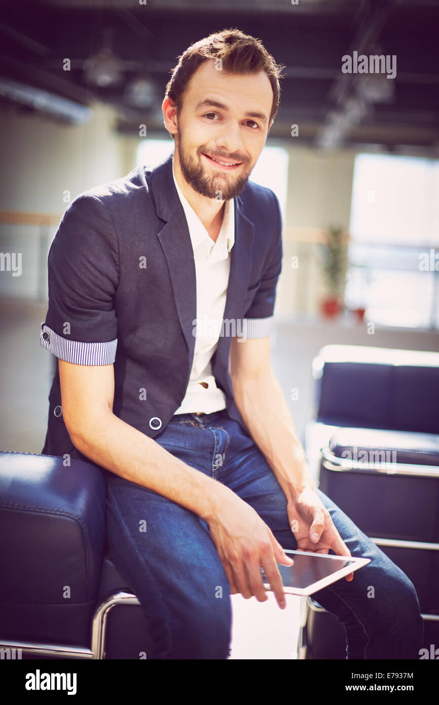 Happy businessman with touchpad looking at camera Stock Photo - Alamy