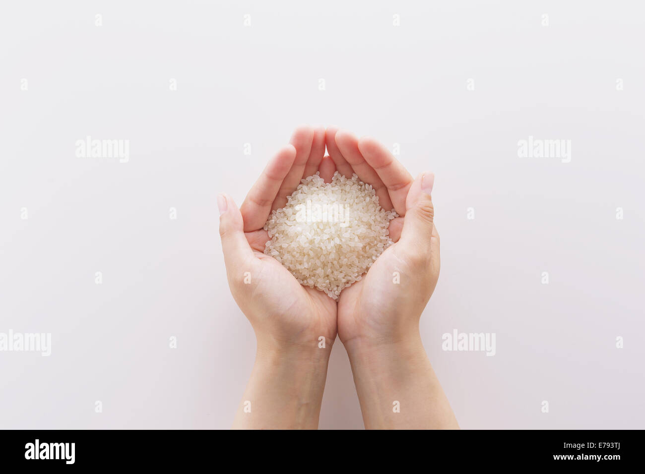 Young Japanese woman holding rice in her hands Stock Photo - Alamy