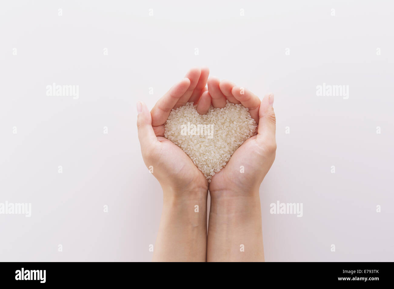 Young Japanese woman holding rice in her hands Stock Photo - Alamy