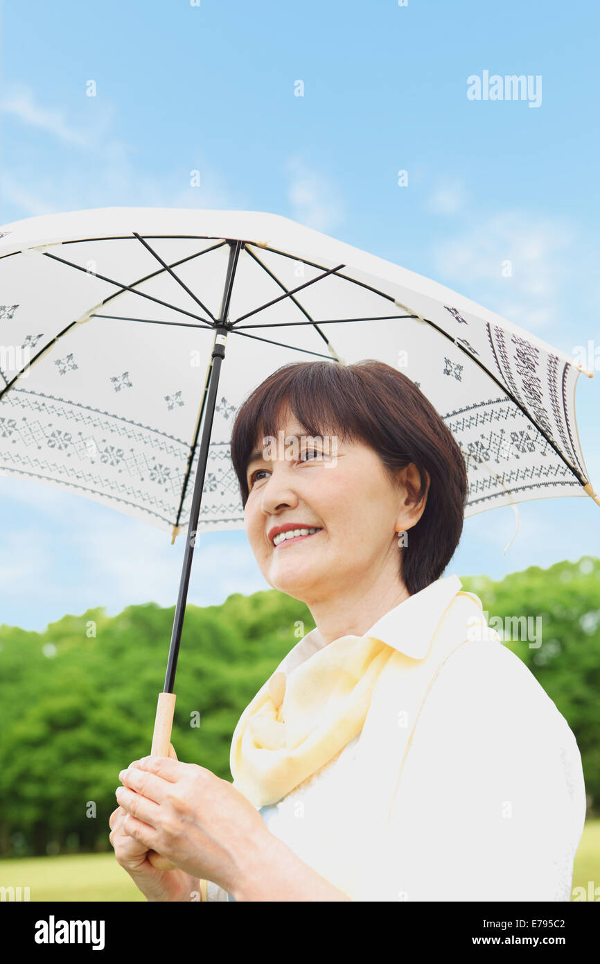 Woman with parasol hi-res stock photography and images - Alamy