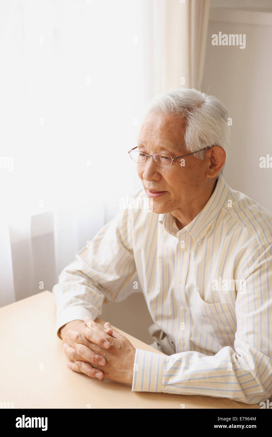 Senior adult Japanese man sitting Stock Photo - Alamy