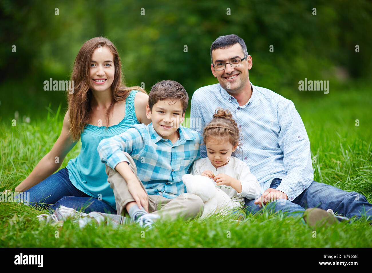 Happy family members relaxing on the lawn in summer Stock Photo - Alamy