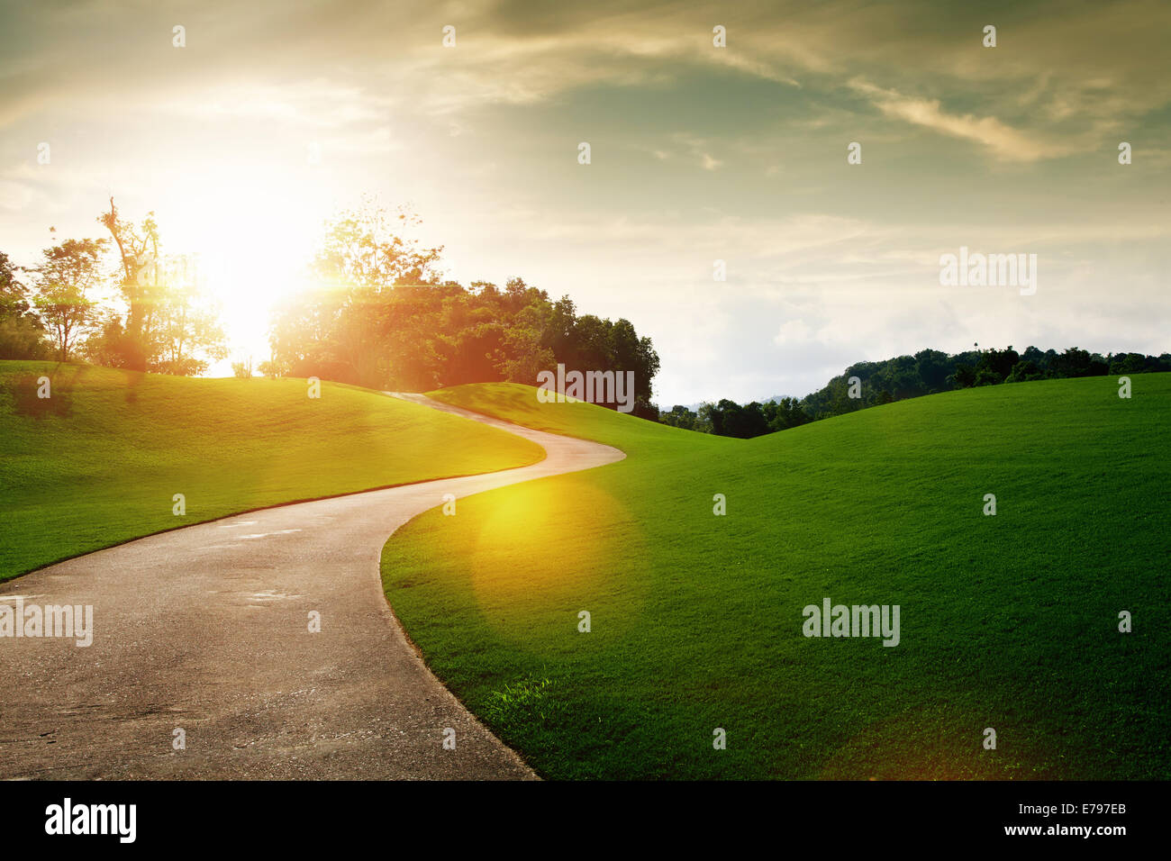 panoramic view of nice green hill and path during sunset Stock Photo ...