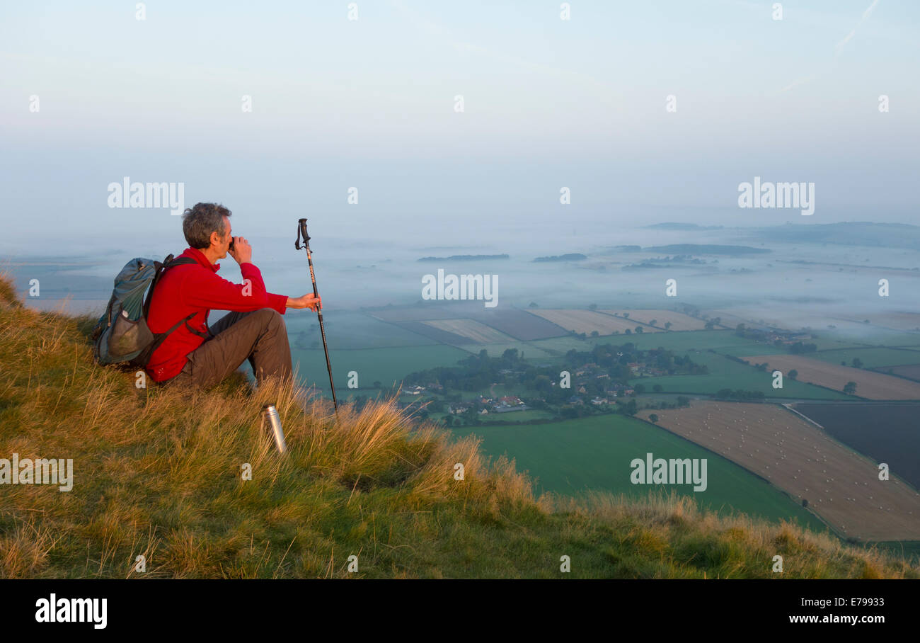 Male hiker, walker on the summit of Roseberry Topping at sunrise. North ...