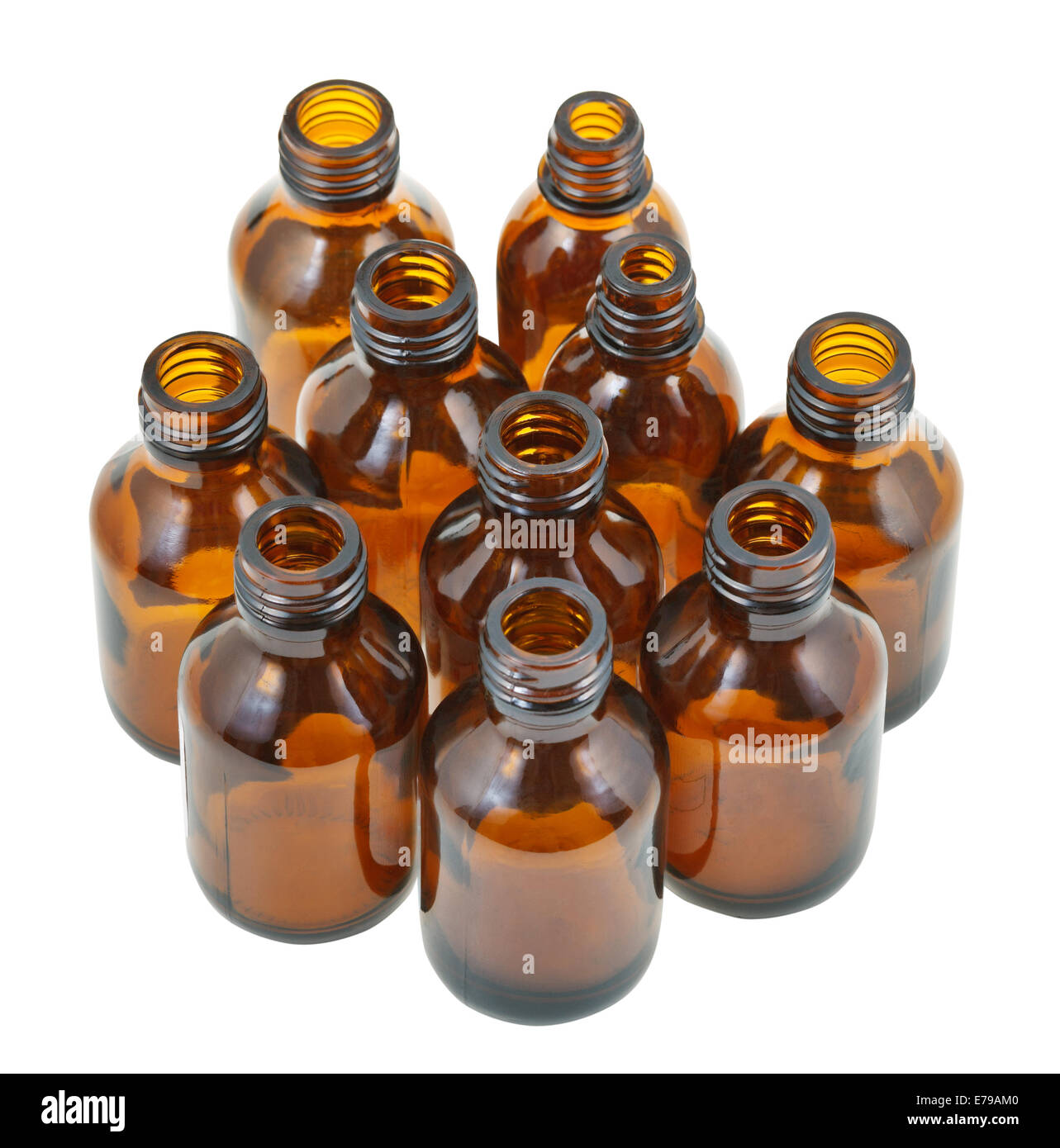 many small open brown glass oval pharmacy bottles isolated on white ...
