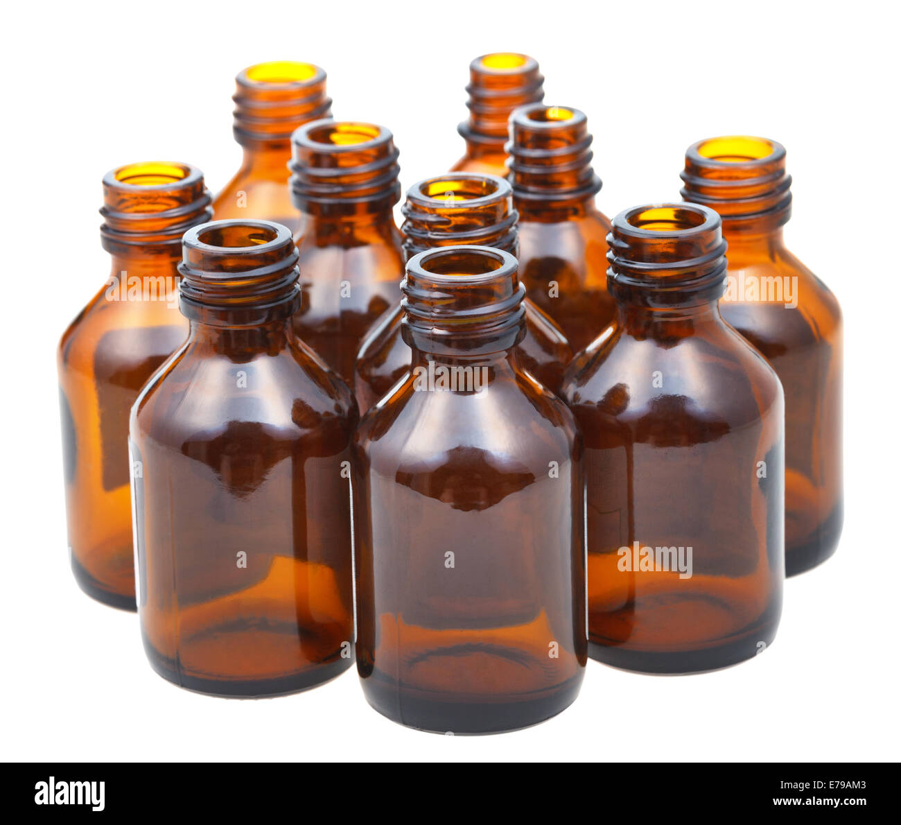 many small open amber glass oval pharmacy bottles isolated on white ...