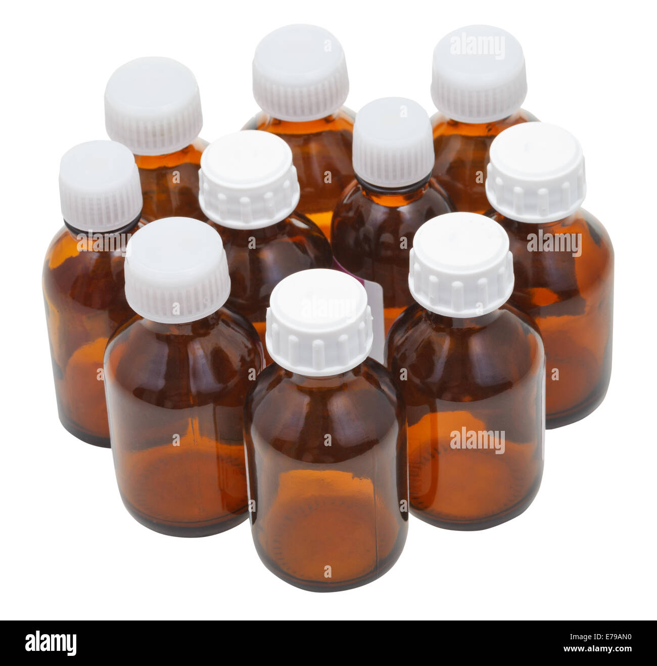 many little closed amber glass oval pharmacy bottles isolated on white ...